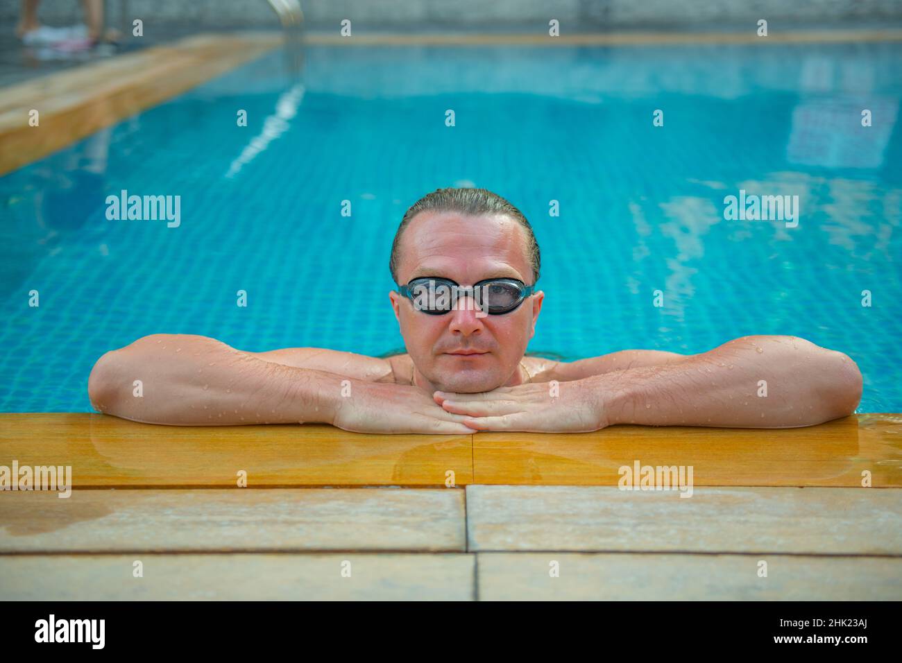 a man with glasses swims in a large pool Stock Photo - Alamy
