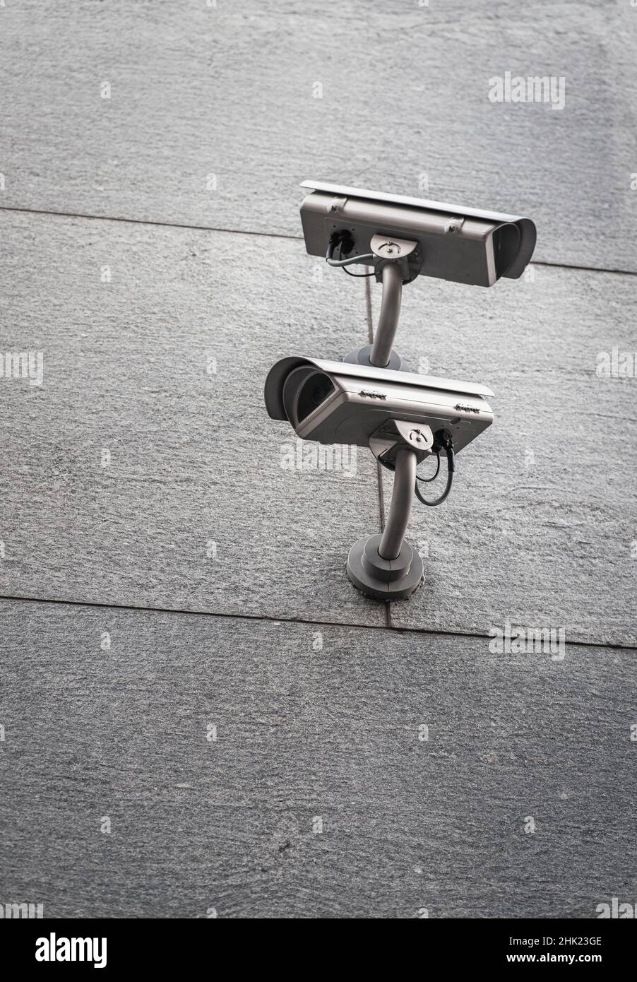 Vertical shot of two street cameras facing opposite directions on a ...