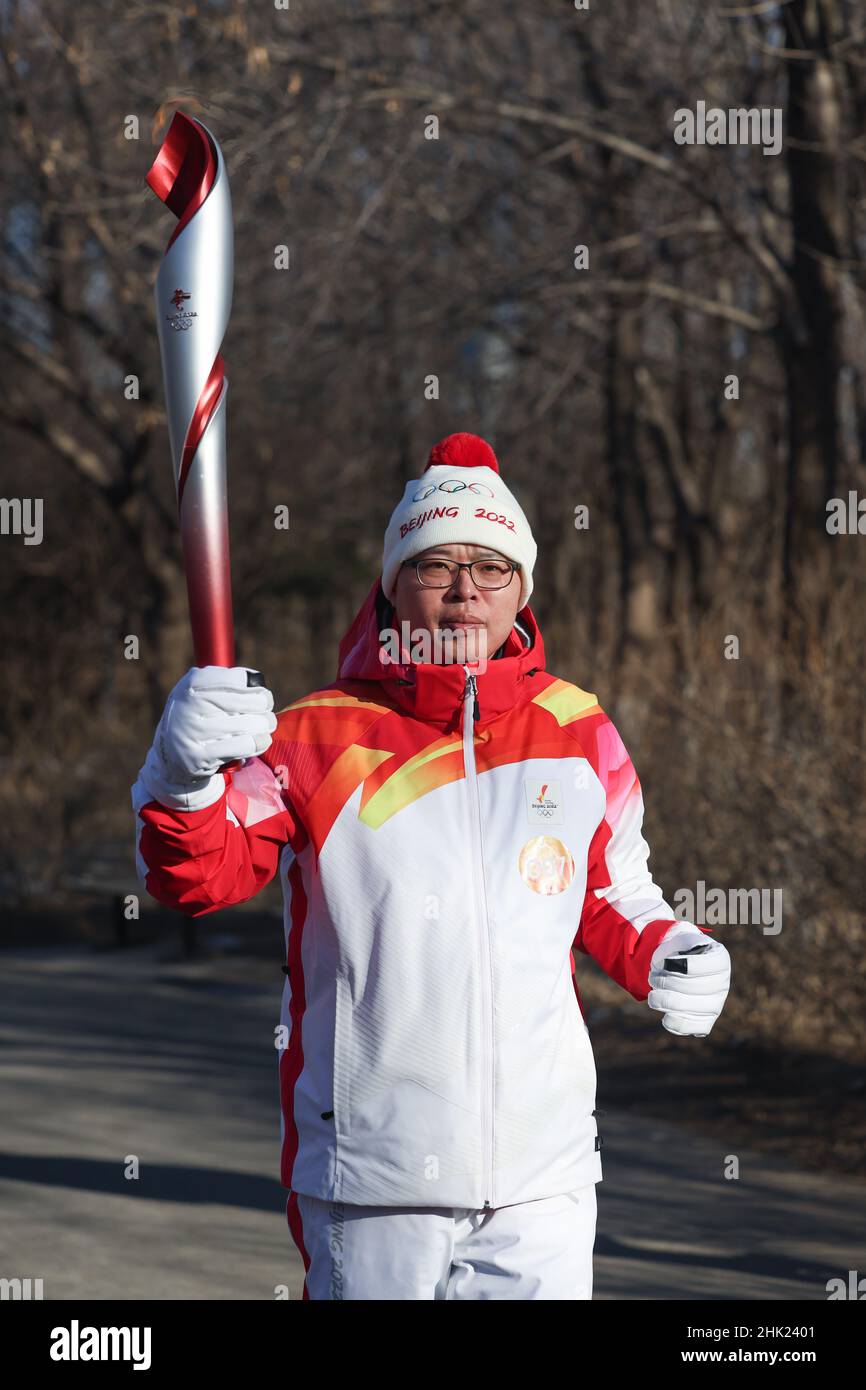 Beijing, China. 2nd Feb, 2022. Torch bearer Li Weihao runs with the torch during the Beijing ...