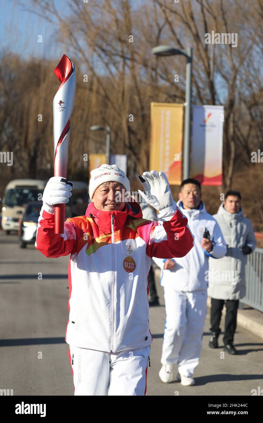 Beijing, China. 2nd Feb, 2022. Torch bearer Xu Zhenchao runs with the torch during the Beijing ...
