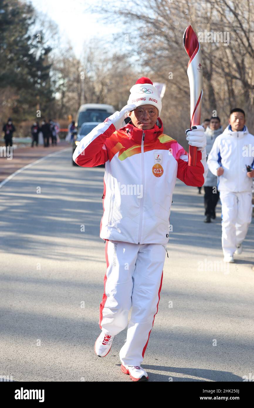 Beijing, China. 2nd Feb, 2022. Torch bearer Zhang Jie runs with the torch during the Beijing ...