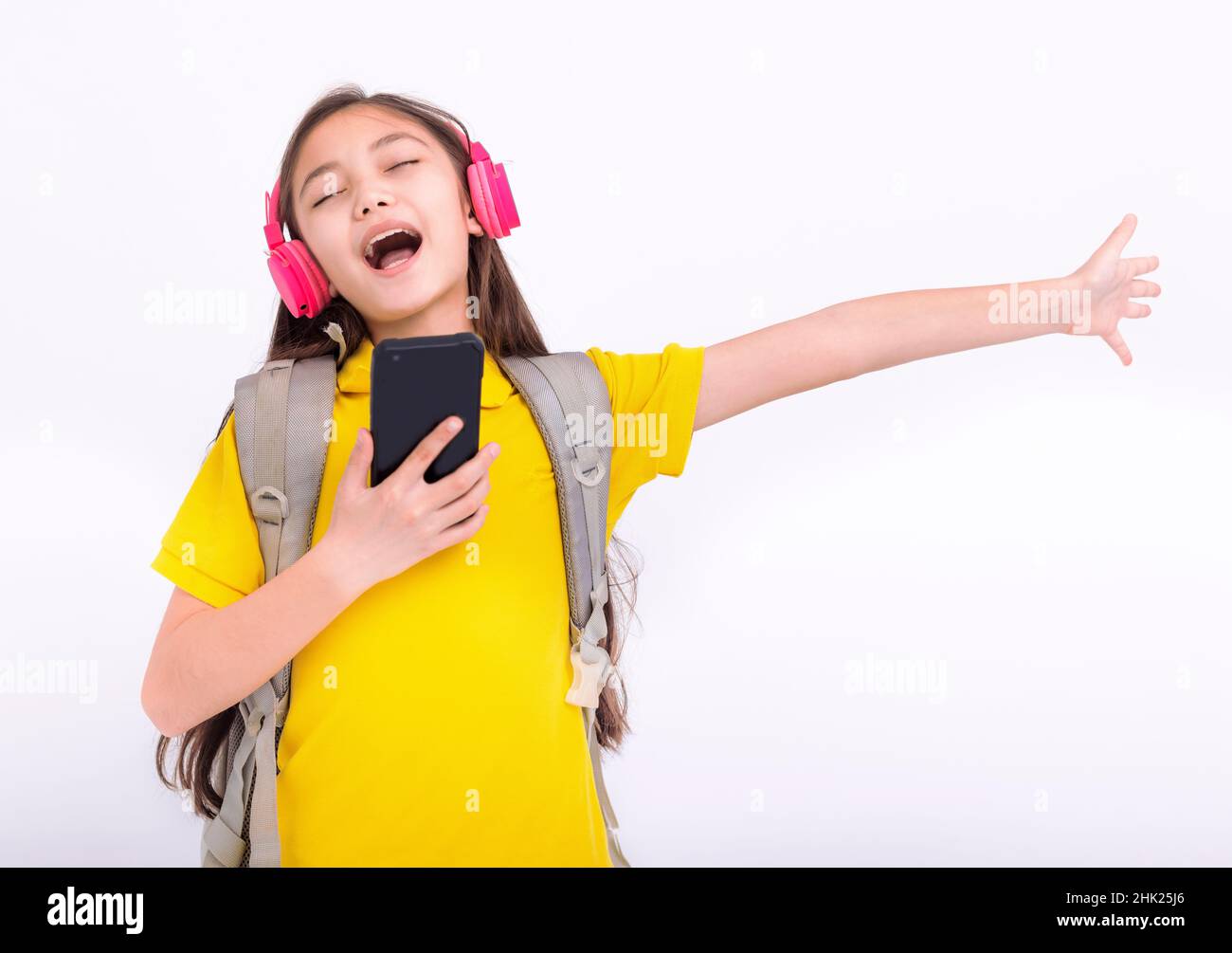 Happy student girl Listening music with headphones and sing song ...