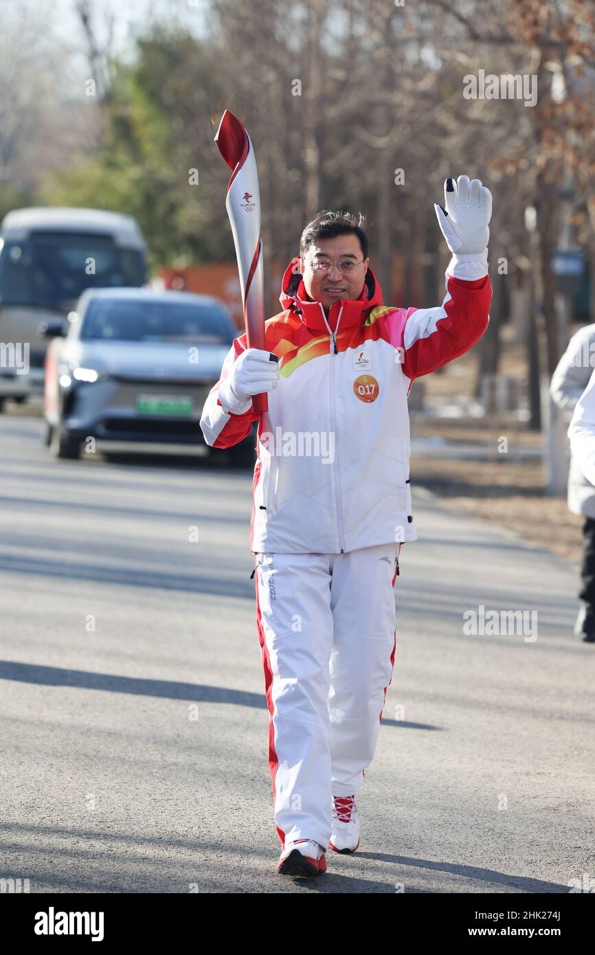 Beijing, China. 2nd Feb, 2022. Torch bearer Pan Gang runs with the torch during the Beijing 2022 ...