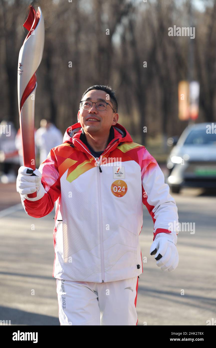 Beijing, China. 2nd Feb, 2022. Torch bearer Zhang Xuesong runs with the torch during the Beijing ...