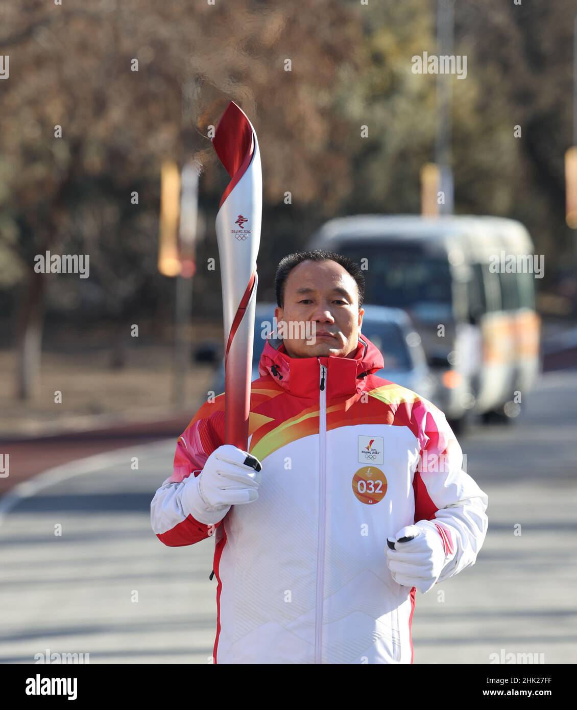 Beijing, China. 2nd Feb, 2022. Torch bearer Li Yonghong runs with the torch during the Beijing ...