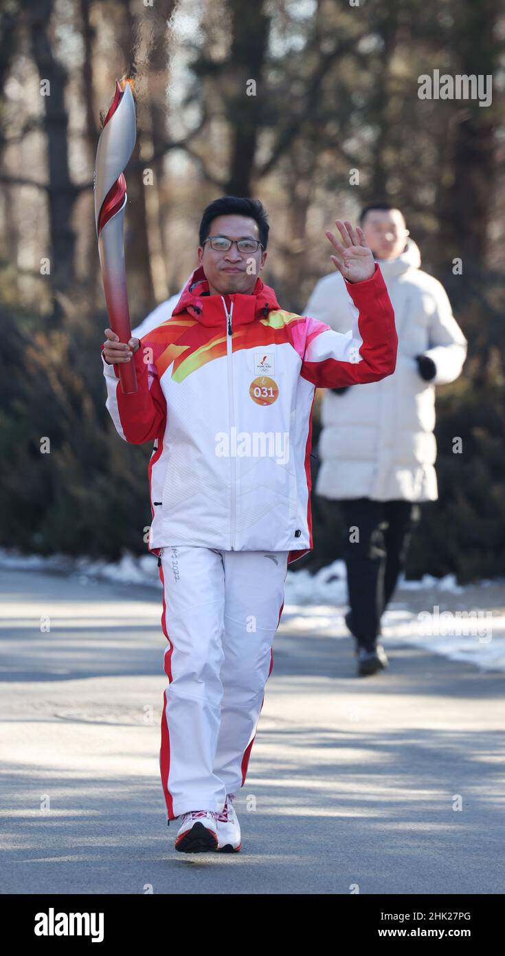 Beijing, China. 2nd Feb, 2022. Torch bearer Shi Peng runs with the ...