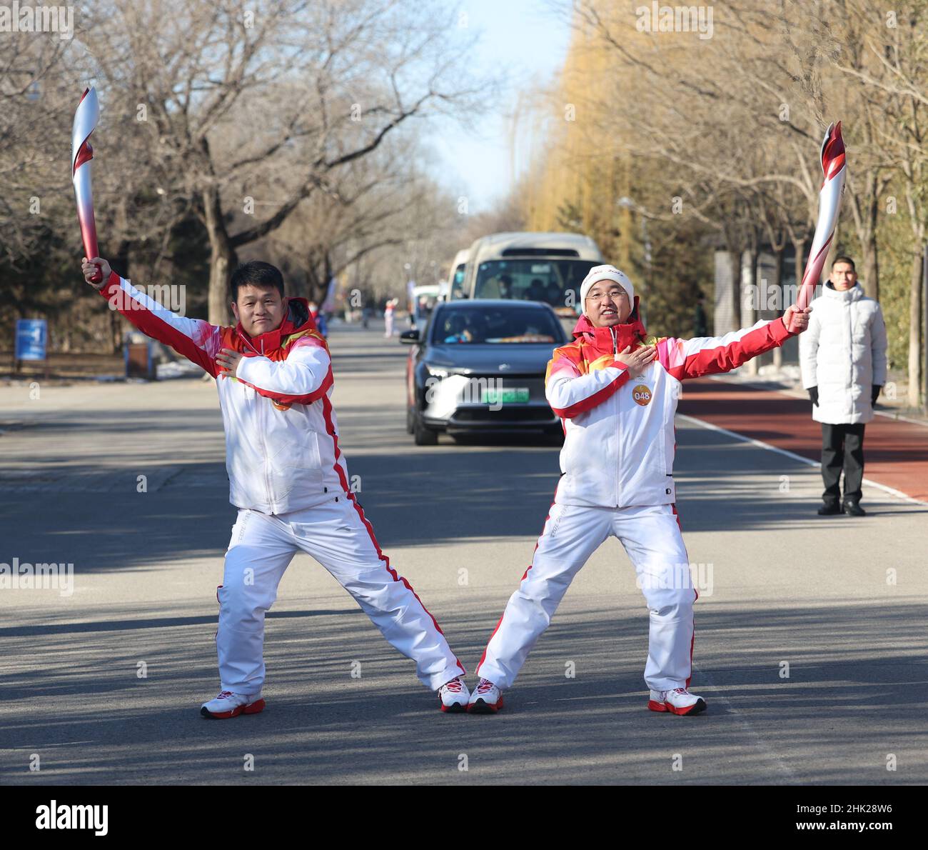 Beijing, China. 2nd Feb, 2022. Torch bearers Wang Jianfeng (R) and ...