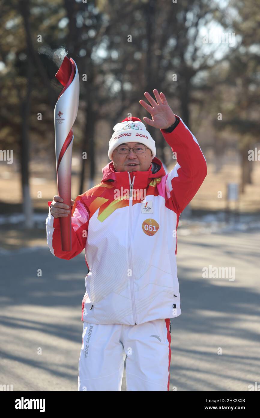 Beijing, China. 2nd Feb, 2022. Torch bearer Zhang Hu runs with the ...