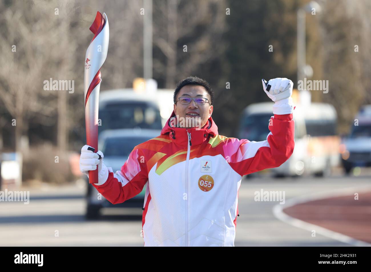 Beijing, China. 2nd Feb, 2022. Torch bearer Ba Genna runs with the torch during the Beijing 2022 ...