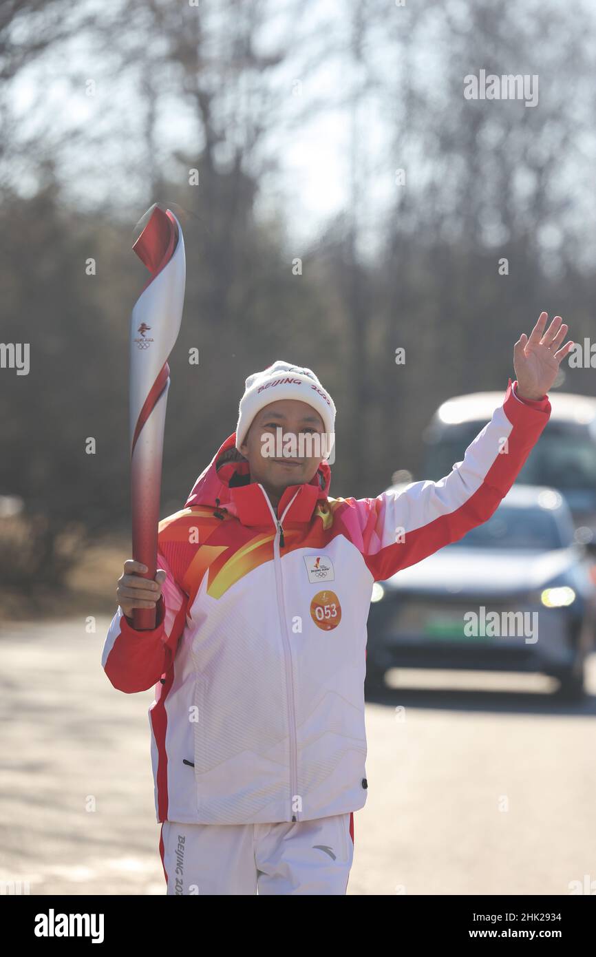 Beijing, China. 2nd Feb, 2022. Torch bearer Qian Yang runs with the torch during the Beijing ...
