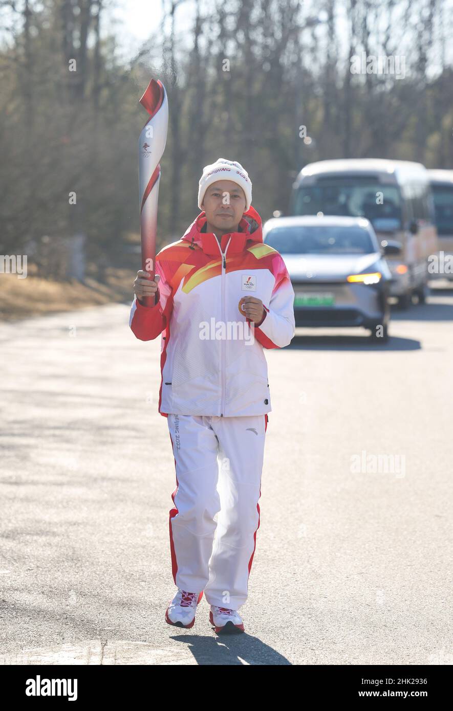 Beijing, China. 2nd Feb, 2022. Torch bearer Qian Yang runs with the torch during the Beijing ...
