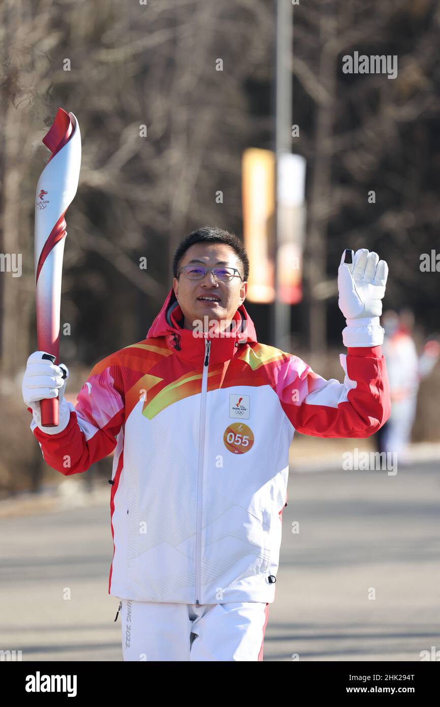 Beijing, China. 2nd Feb, 2022. Torch bearer Ba Genna runs with the torch during the Beijing 2022 ...