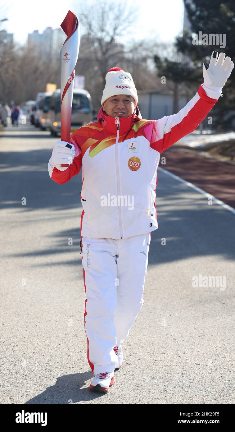 Beijing, China. 2nd Feb, 2022. Torch bearer Fu Chunlai runs with the ...