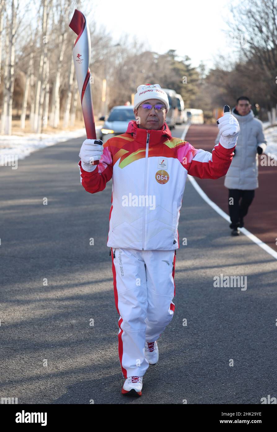 Beijing, China. 2nd Feb, 2022. Torch bearer Bi Mingwei runs with the ...