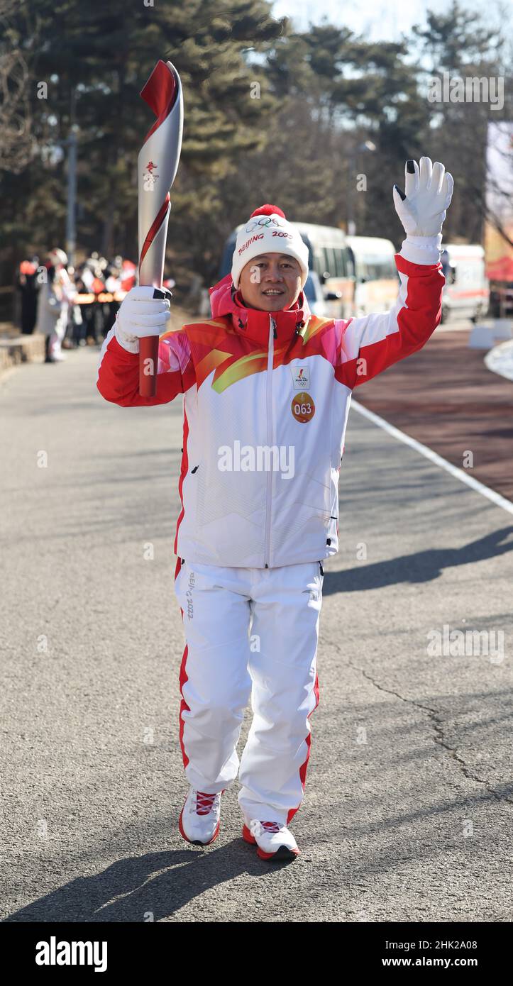 Beijing, China. 2nd Feb, 2022. Torch bearer Wu Yonghua runs with the ...