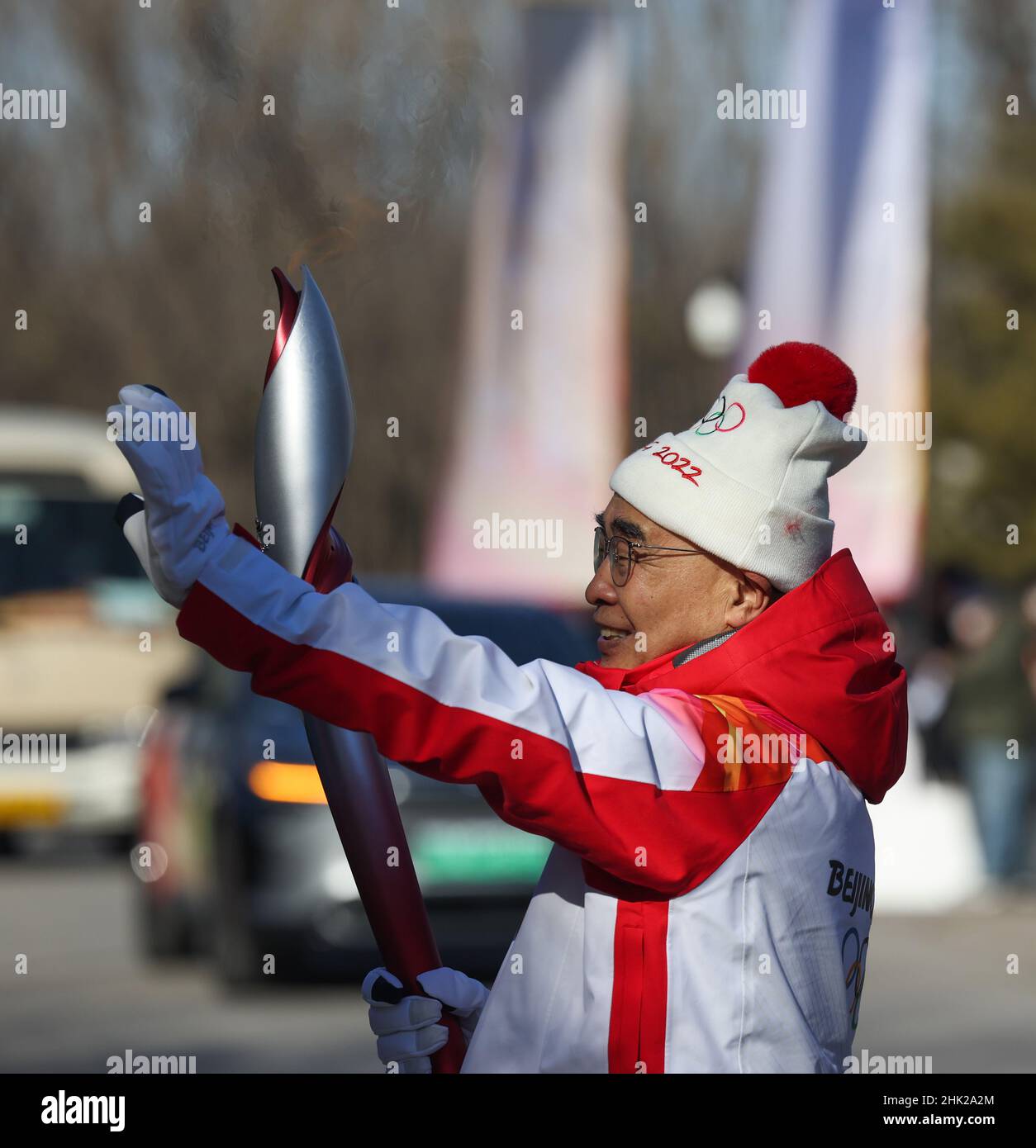 Beijing, China. 2nd Feb, 2022. Torch bearer Zhang Boli runs with the torch during the Beijing ...