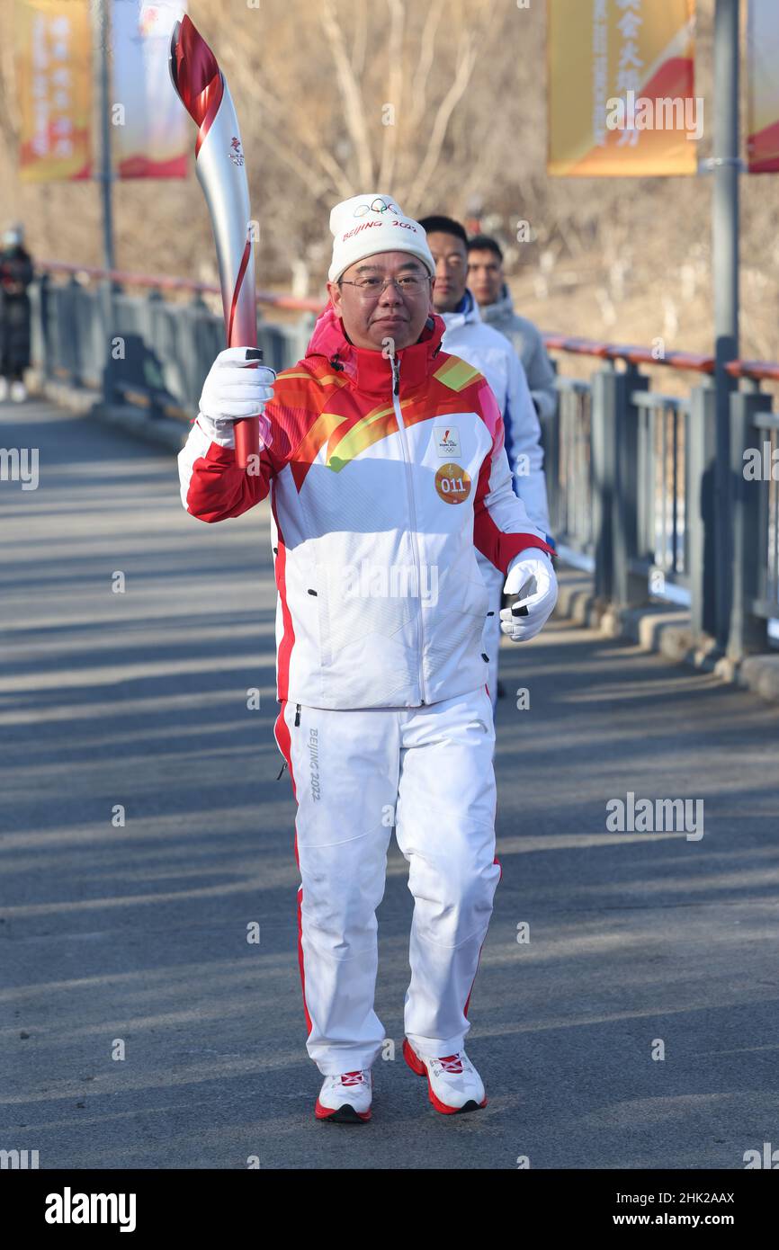 Beijing, China. 2nd Feb, 2022. Torch bearer Wu Ming runs with the torch during the Beijing 2022 ...
