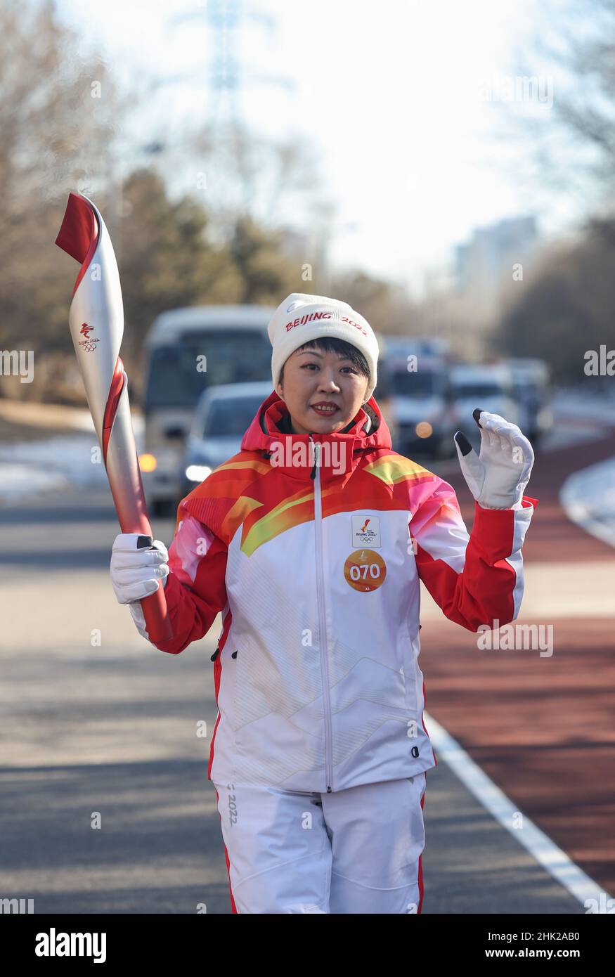 Beijing, China. 2nd Feb, 2022. Torch bearer Liu Yan runs with the torch ...