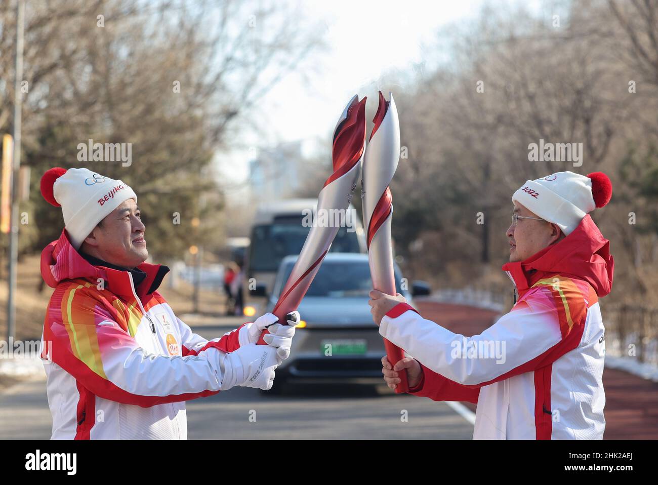 Beijing, China. 2nd Feb, 2022. Torch bearers Zhang Mingdong (R) and ...