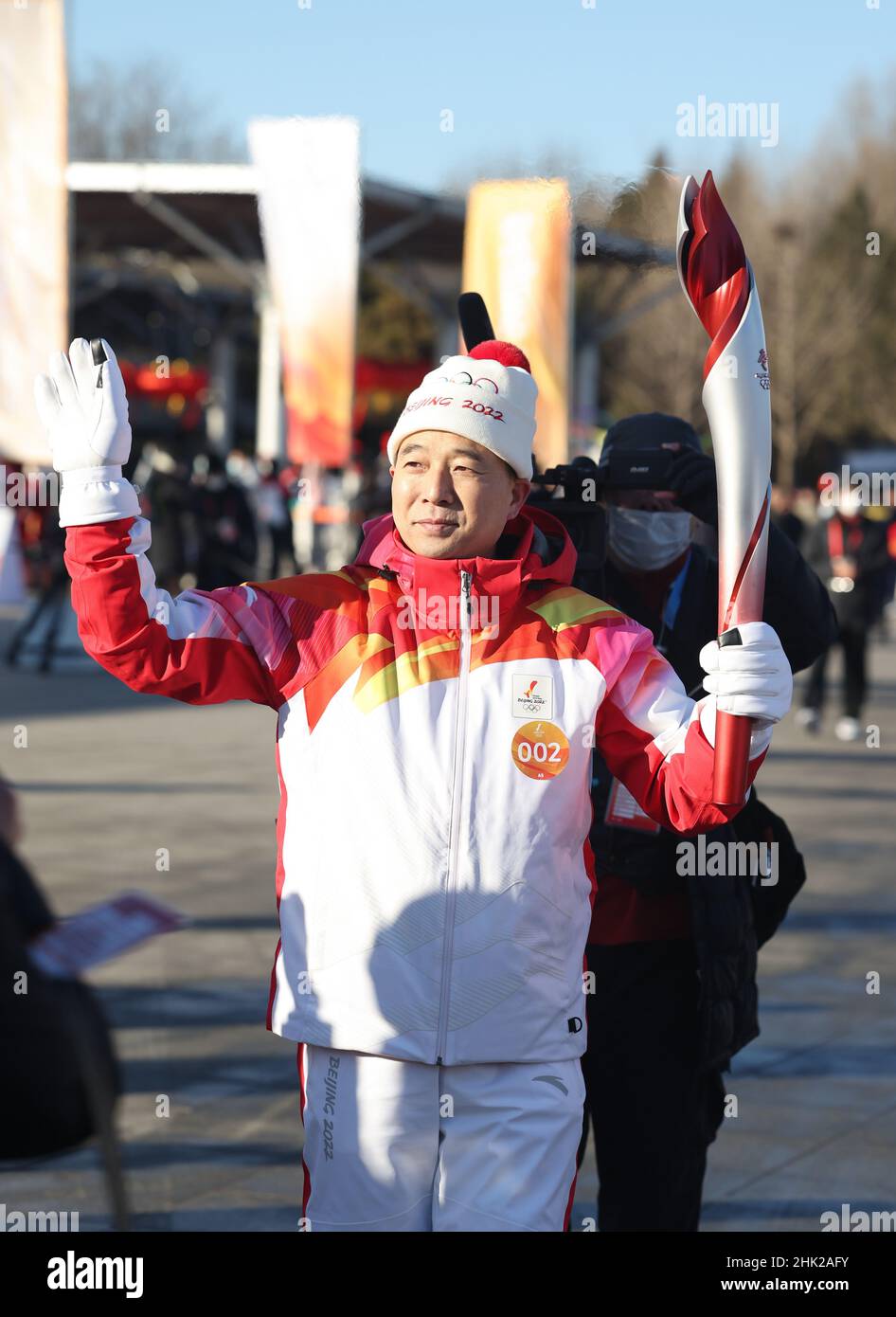 Beijing, China. 2nd Feb, 2022. Torch bearer Jing Haipeng runs with the ...
