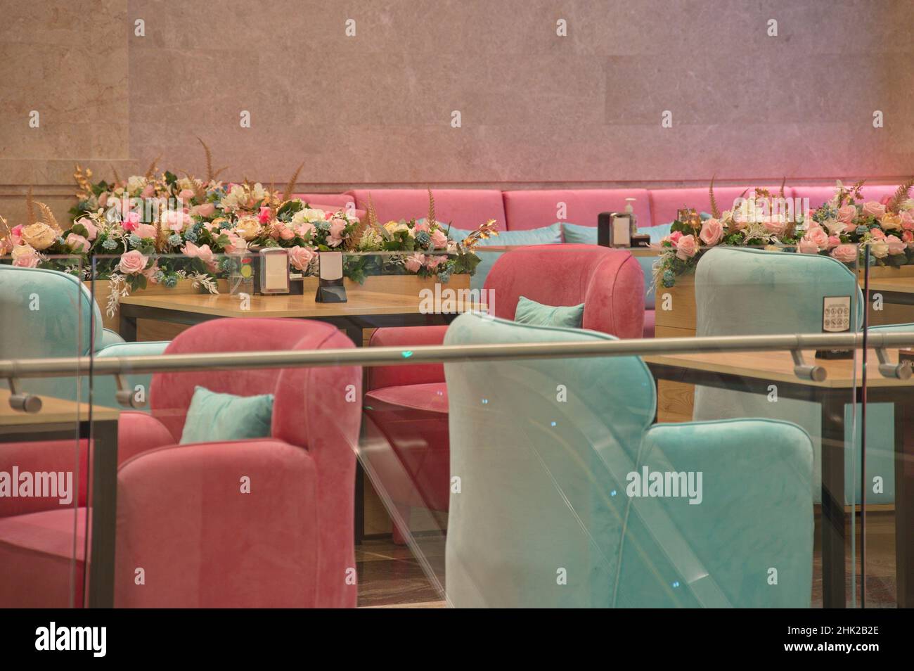 Table and chairs in pastel colors in restaurant Stock Photo - Alamy