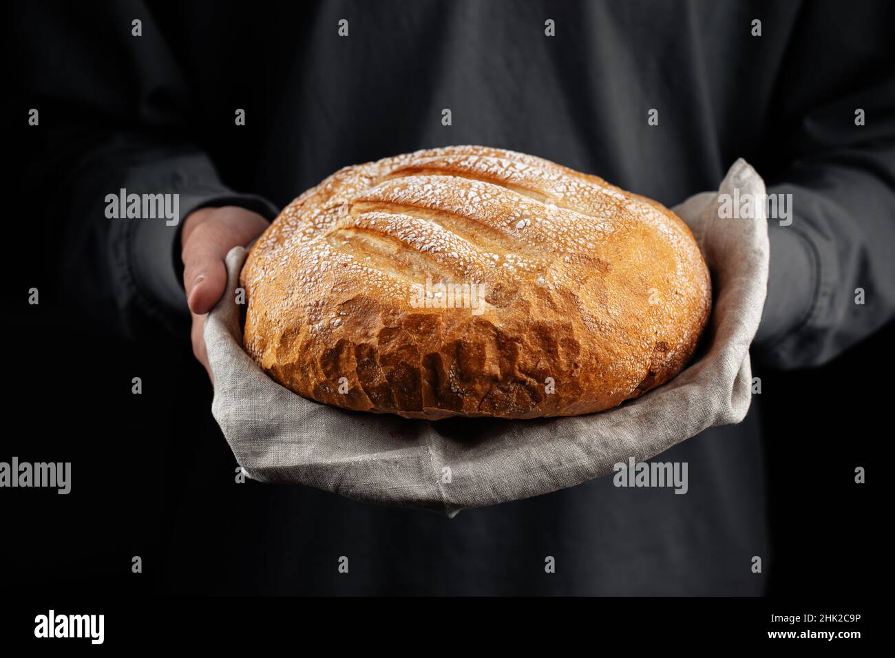 Hands holding loaf bread in hi-res stock photography and images - Alamy