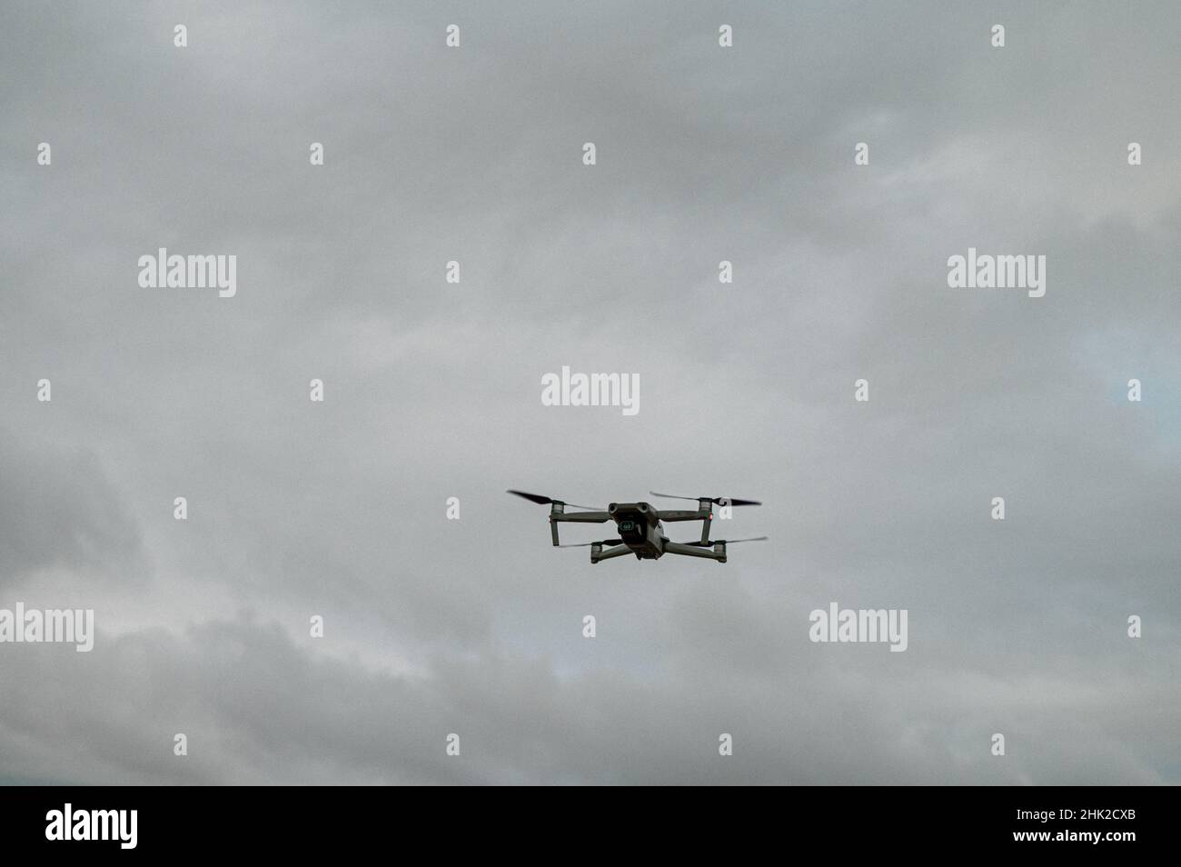 Drone seen flying in sky shot from below Stock Photo - Alamy