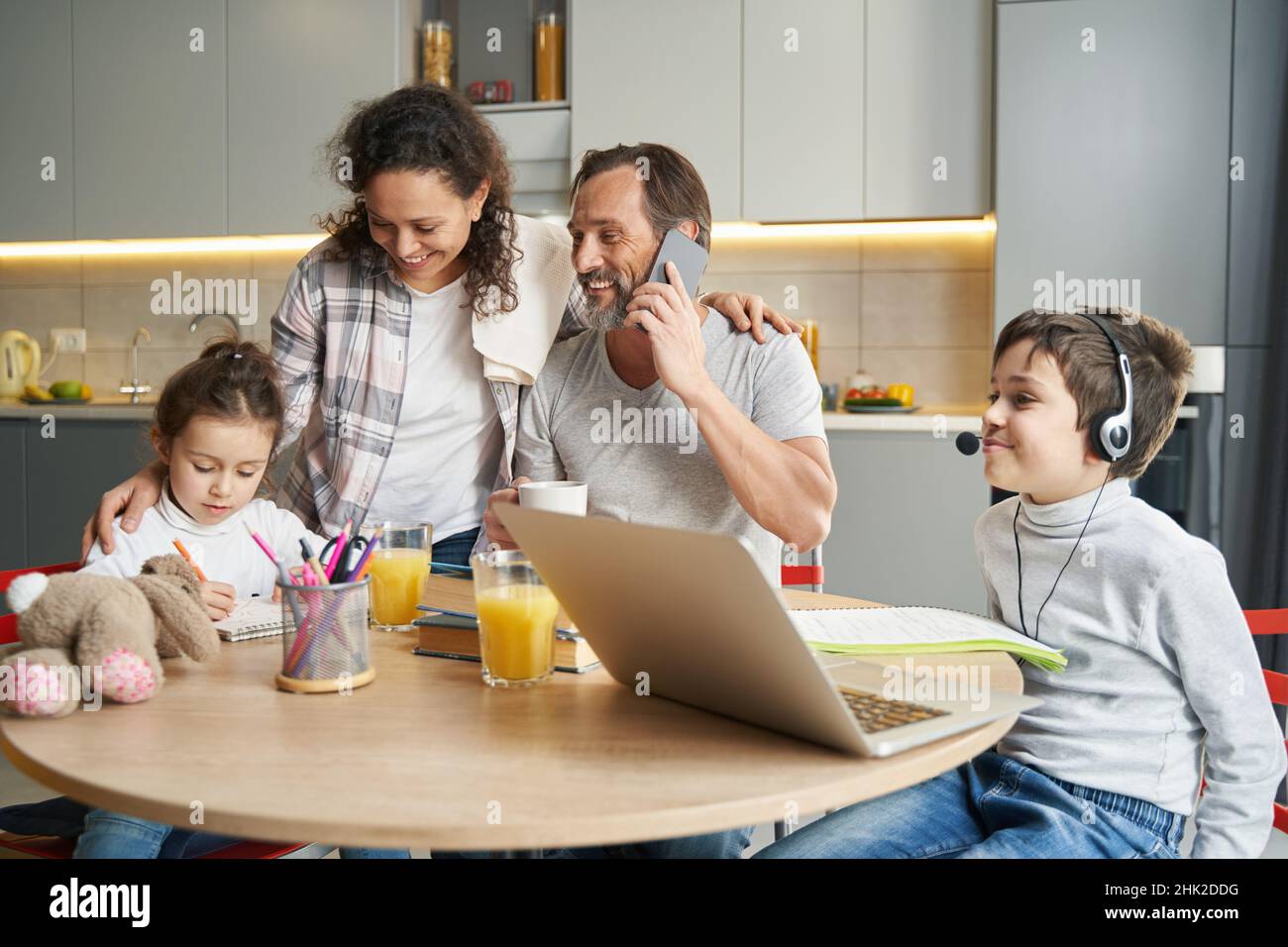 Joyful parents proud of their daughter, painting in notepad Stock Photo ...