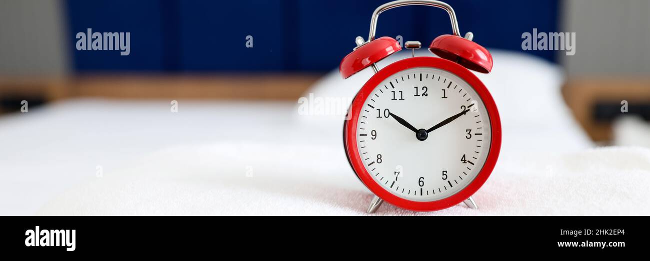 Red alarm clock for ten in morning is on towel Stock Photo - Alamy