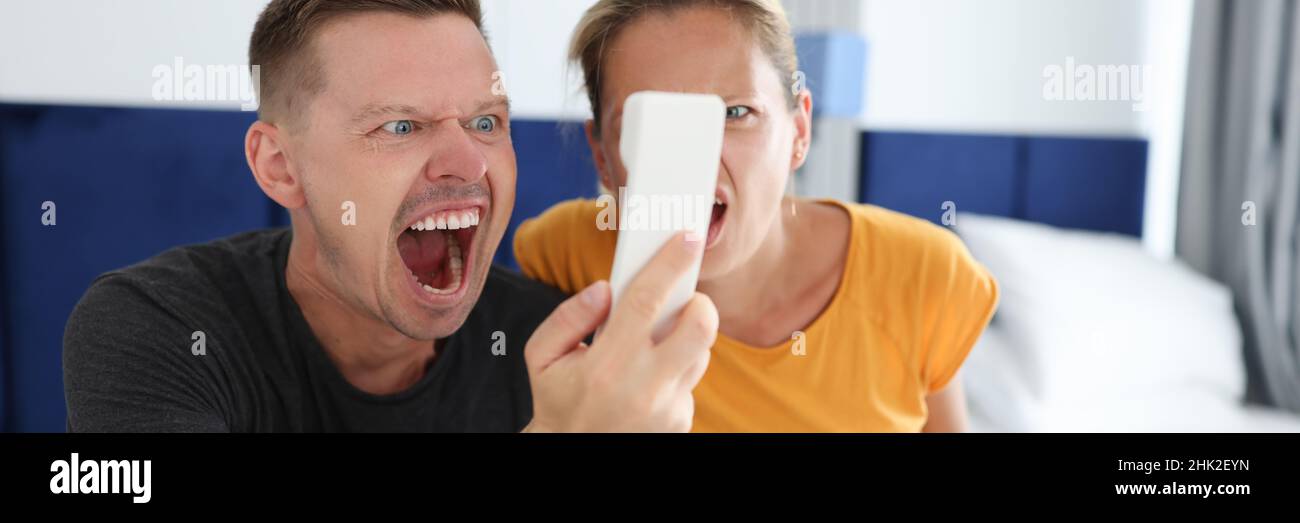 Man and woman are shouting into telephone receiver in hotel room Stock ...