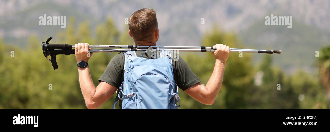 Man hiker is holding Finnish walking sticks to top of mountain Stock ...