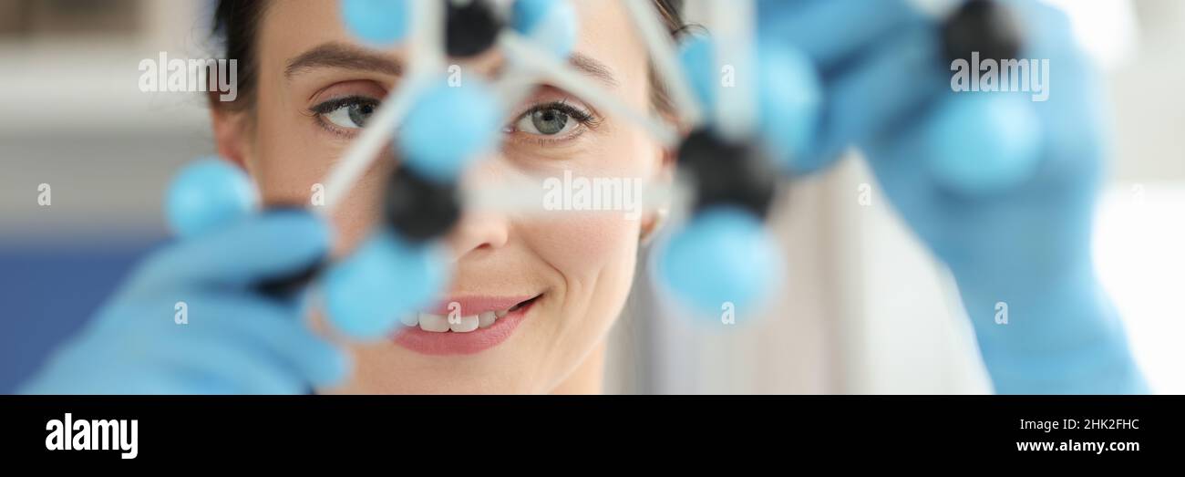 Woman scientist looks at dna layout closeup Stock Photo - Alamy