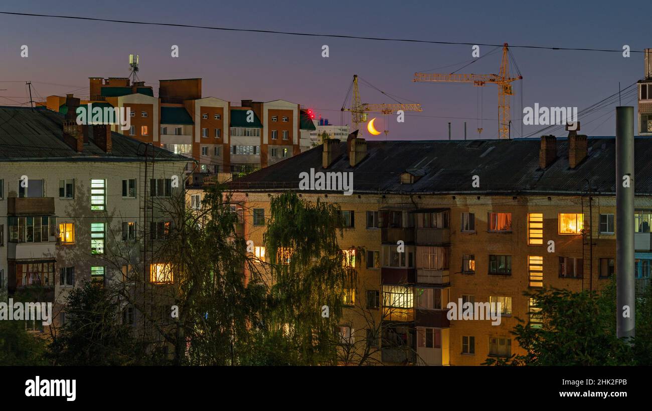 Light in the windows of high-rise buildings at night in summer and half ...