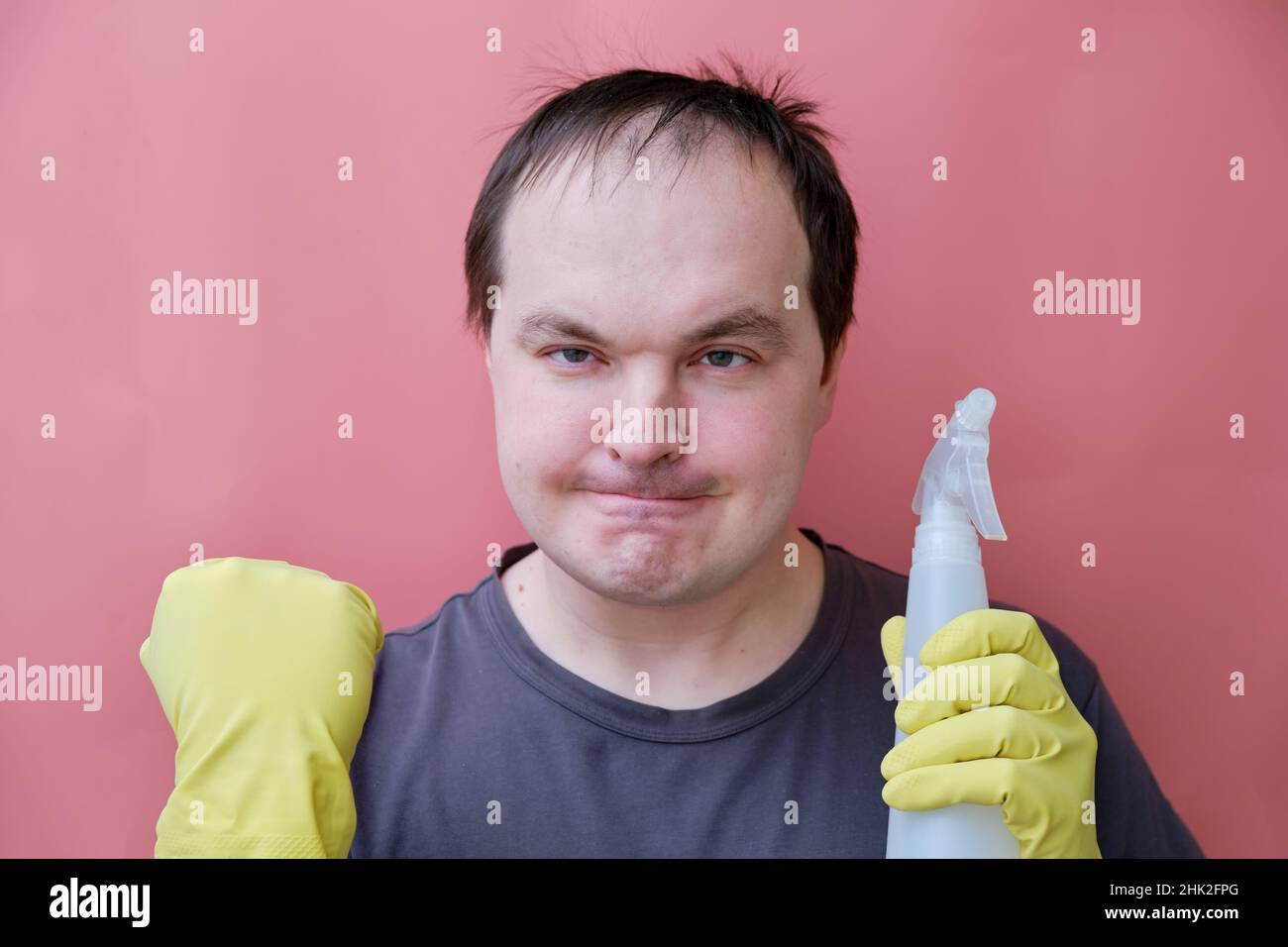 Happy man janitor showing yes gesture in yellow gloves, portrait on ...