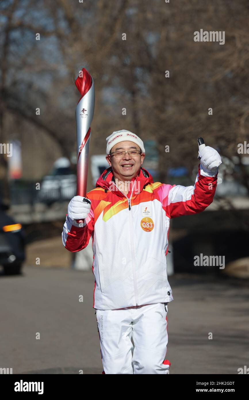 Beijing, China. 2nd Feb, 2022. Torch bearer Zou Caineng runs with the ...