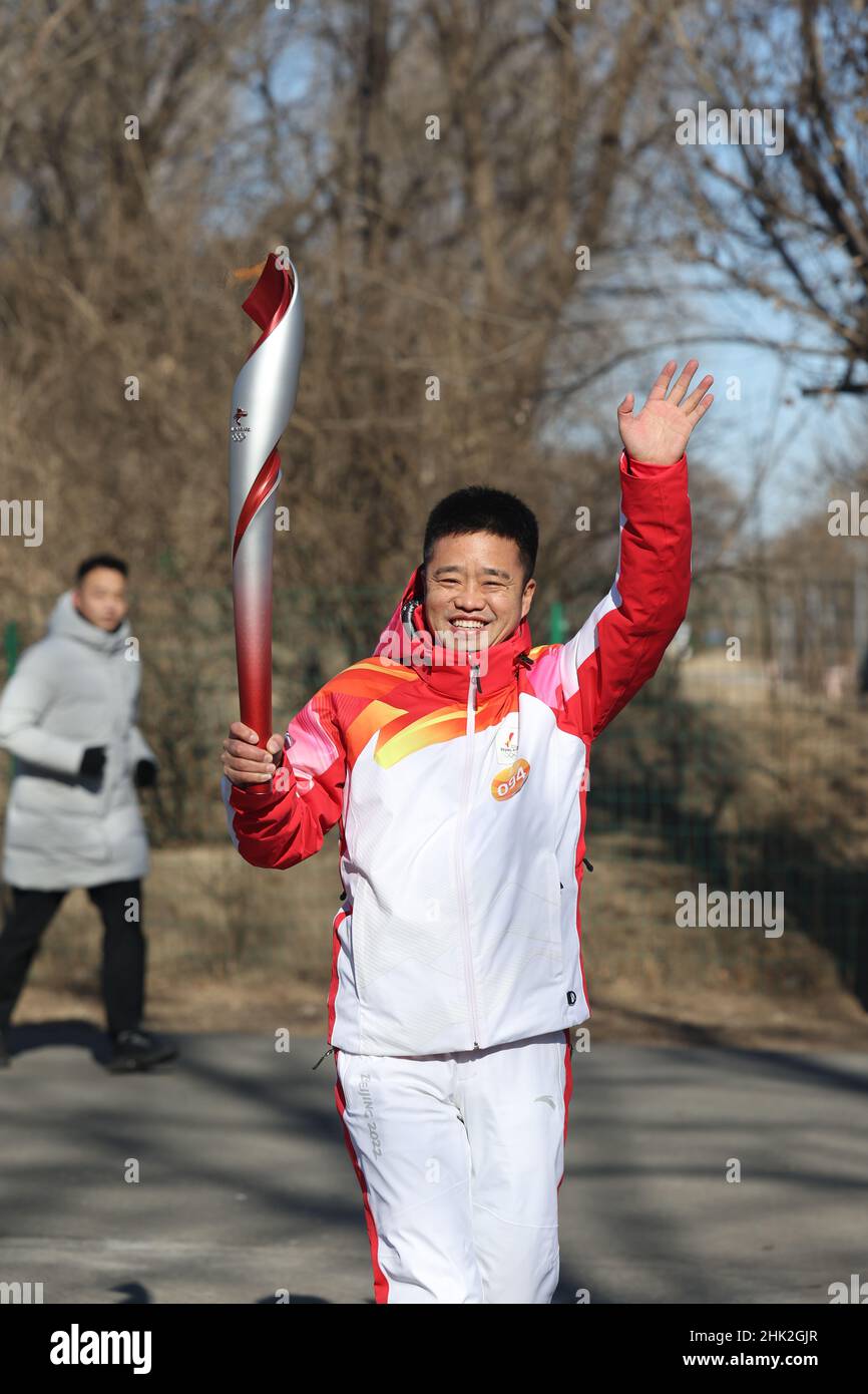 Beijing, China. 2nd Feb, 2022. Torch bearer Chen Chunguang runs with the torch during the ...