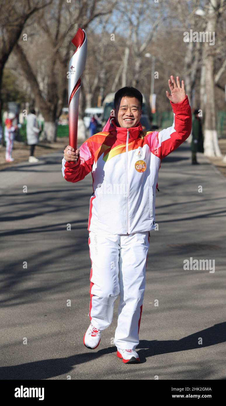 Beijing, China. 2nd Feb, 2022. Torch bearer Chen Chunguang runs with the torch during the ...