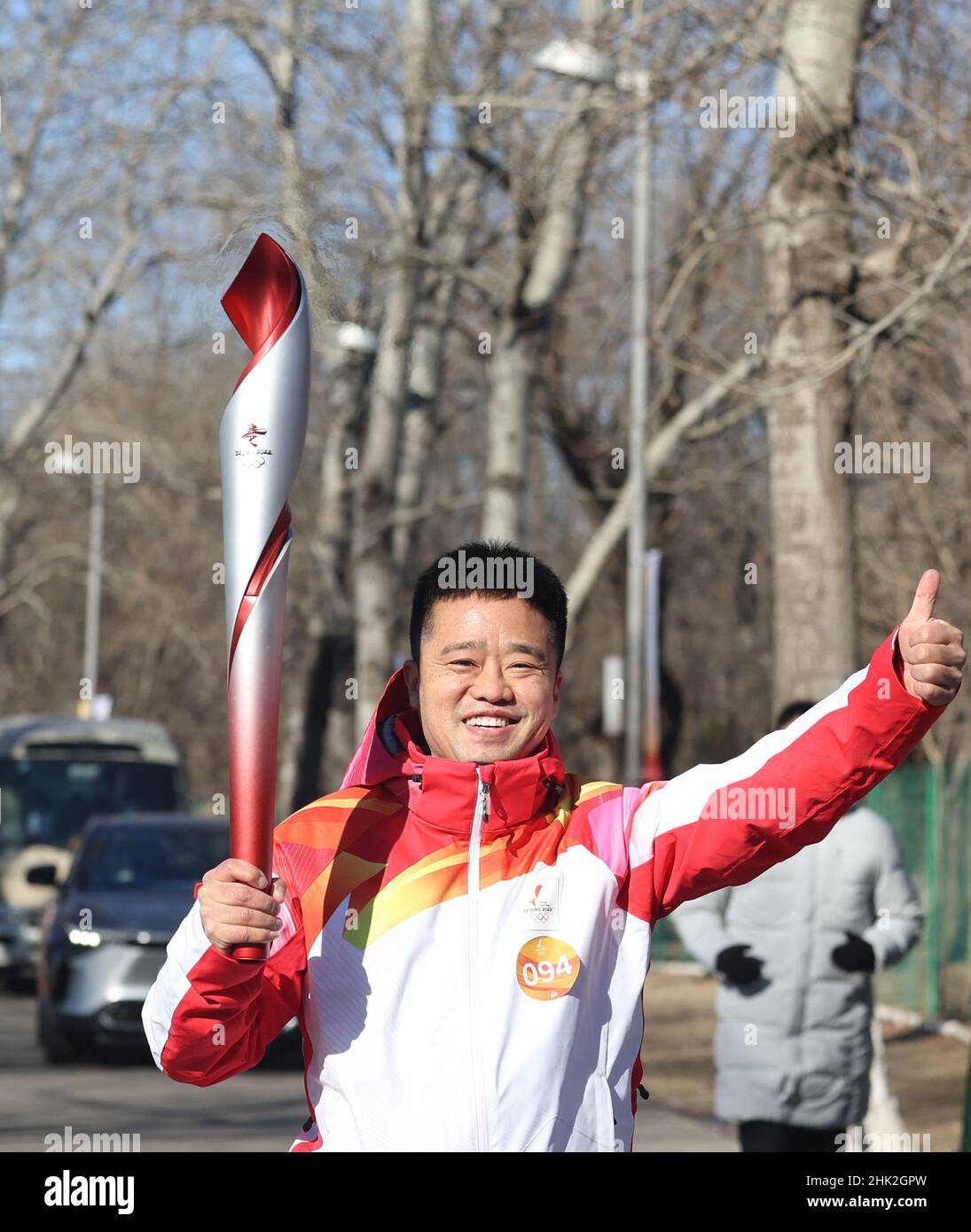 Beijing, China. 2nd Feb, 2022. Torch bearer Chen Chunguang runs with the torch during the ...