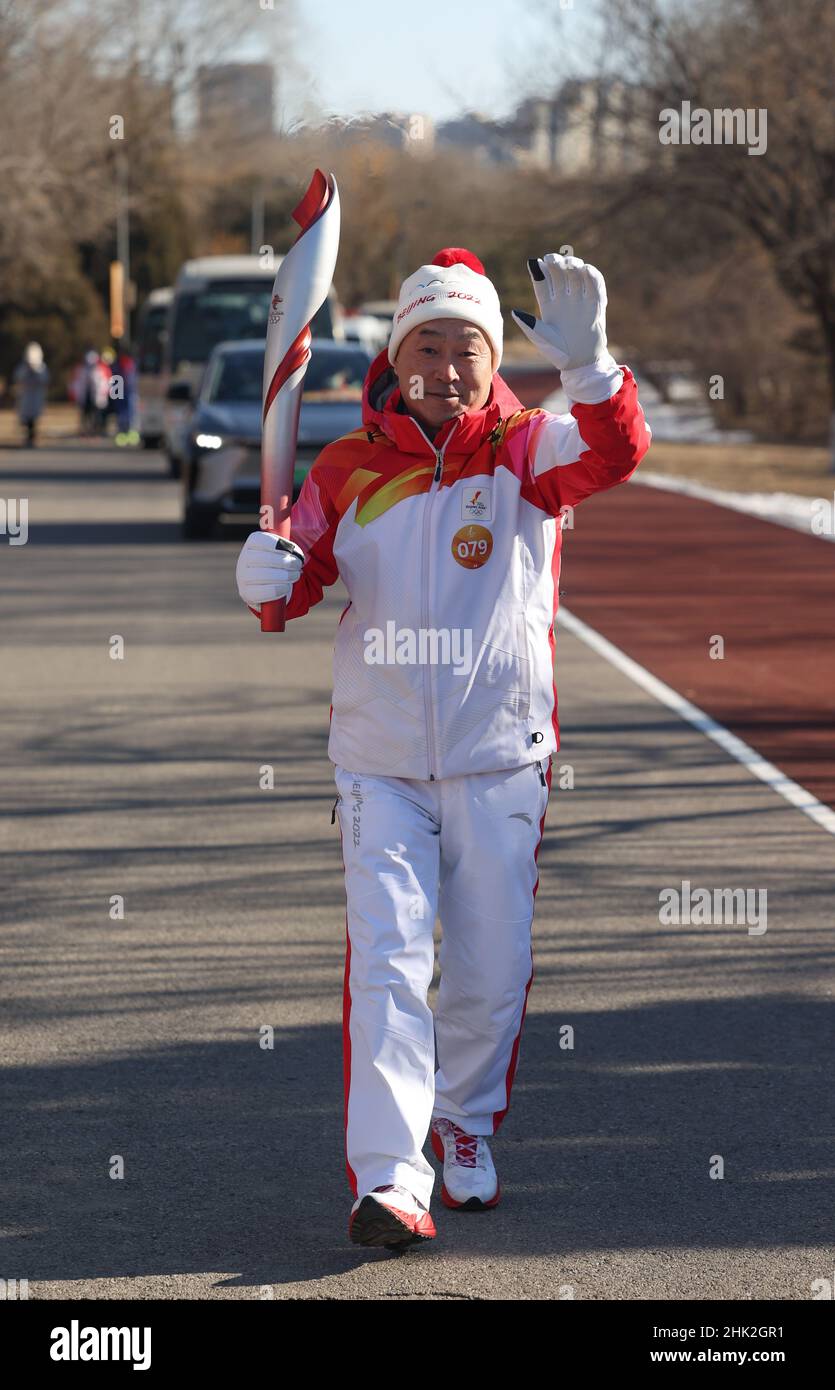 Beijing, China. 2nd Feb, 2022. Torch bearer Li Xinmin runs with the torch during the Beijing ...