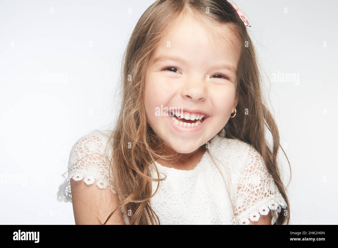 Cute little girl who puts a radiant smile on her face accompanied by ...