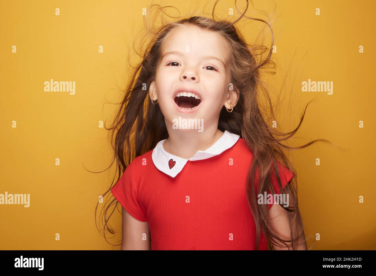 Cute little girl who puts a radiant smile on her face accompanied by ...