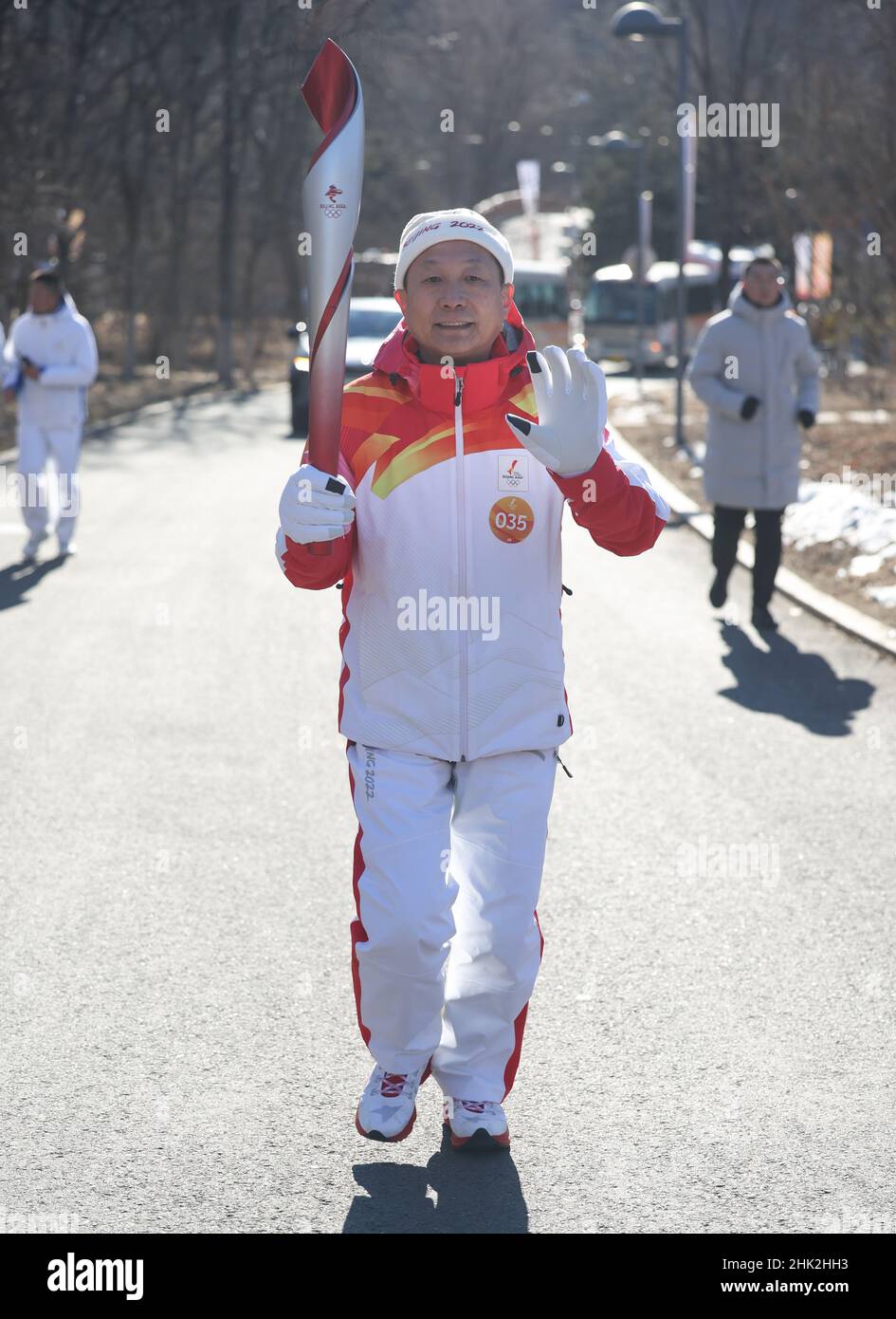 Beijing, China. 2nd Feb, 2022. Torch bearer Chen Jihua runs with the torch during the Beijing ...