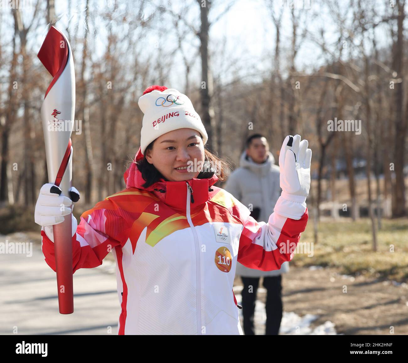 Beijing, China. 2nd Feb, 2022. Torch bearer Bai Kun runs with the torch ...
