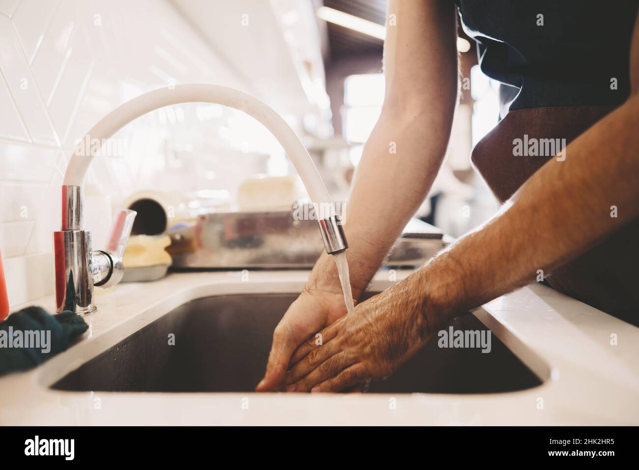 Chef washing his hands in a restaurant kitchen sink Stock Photo - Alamy