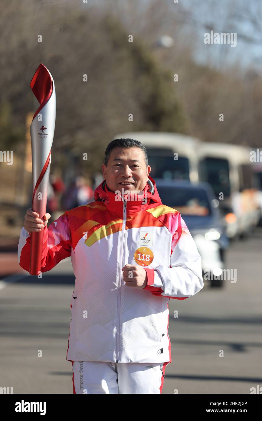 Beijing, China. 2nd Feb, 2022. Torch bearer Li Mingxin runs with the torch during the Beijing ...