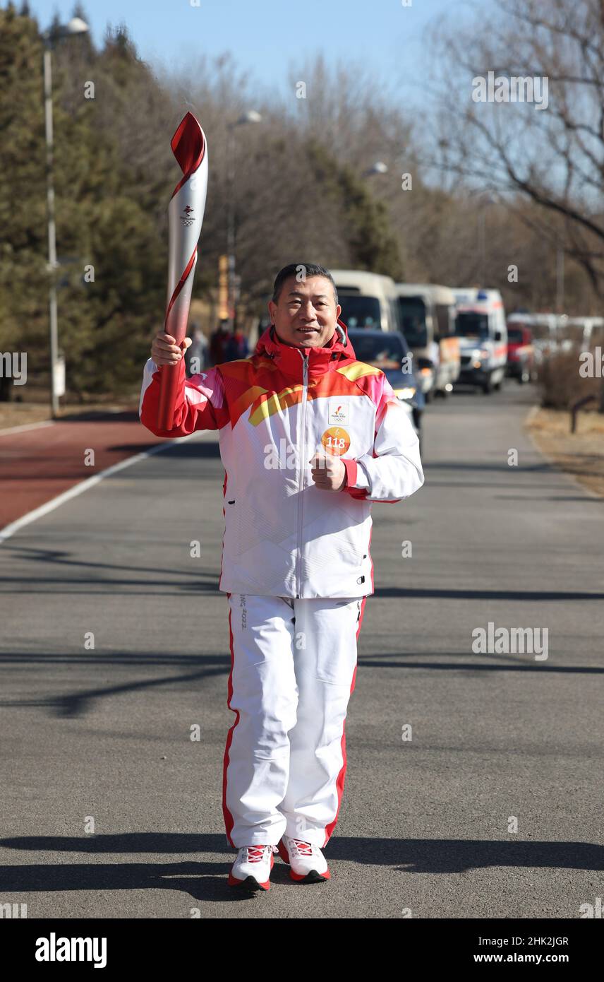 Beijing, China. 2nd Feb, 2022. Torch bearer Li Mingxin runs with the ...