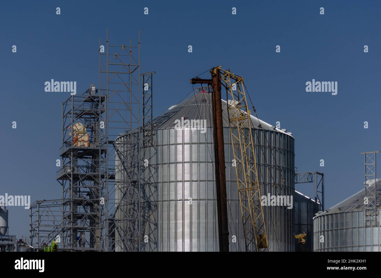 Construction site. Installation of cylindrical silos for grain storage ...