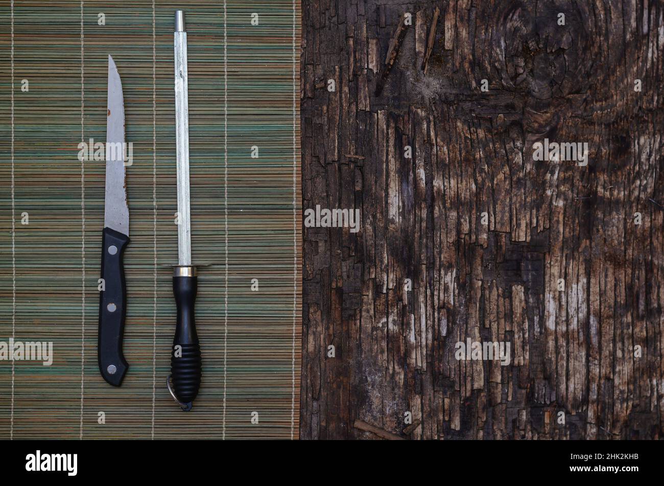 Old kitchen knife, Honing steel and bamboo cloth on dark wooden ...
