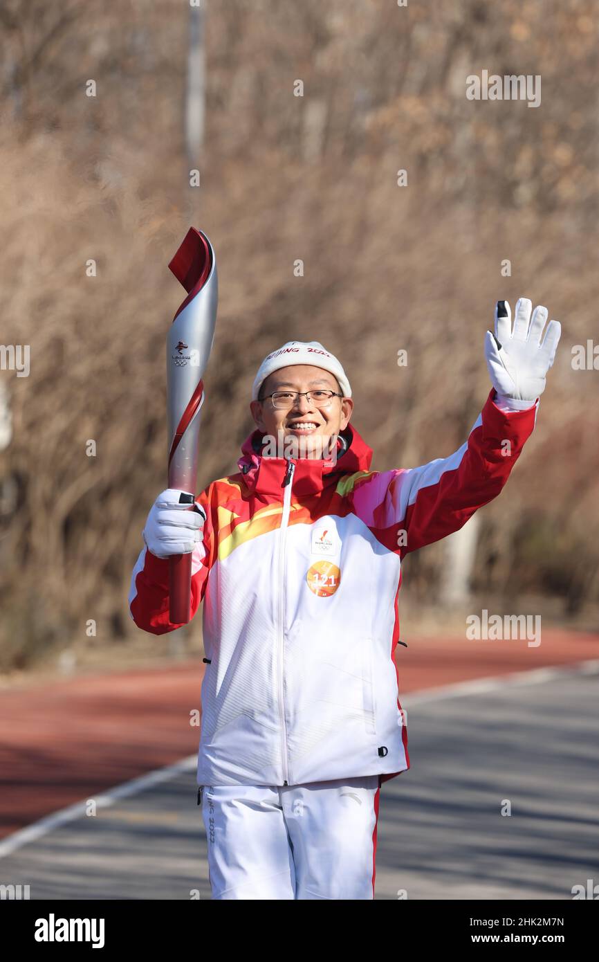 Beijing, China. 2nd Feb, 2022. Torch bearer Wang Bo runs with the torch during the Beijing 2022 ...