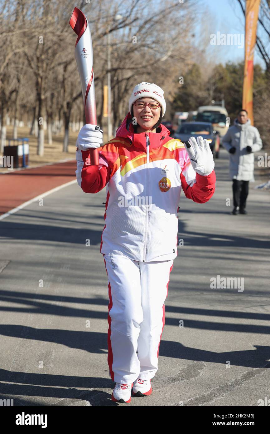 Beijing, China. 2nd Feb, 2022. Torch bearer Tan Si runs with the torch during the Beijing 2022 ...